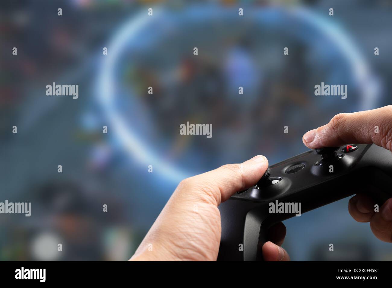 Gamer plays a video game. He has a GAM22ICB joystick in his hands ...