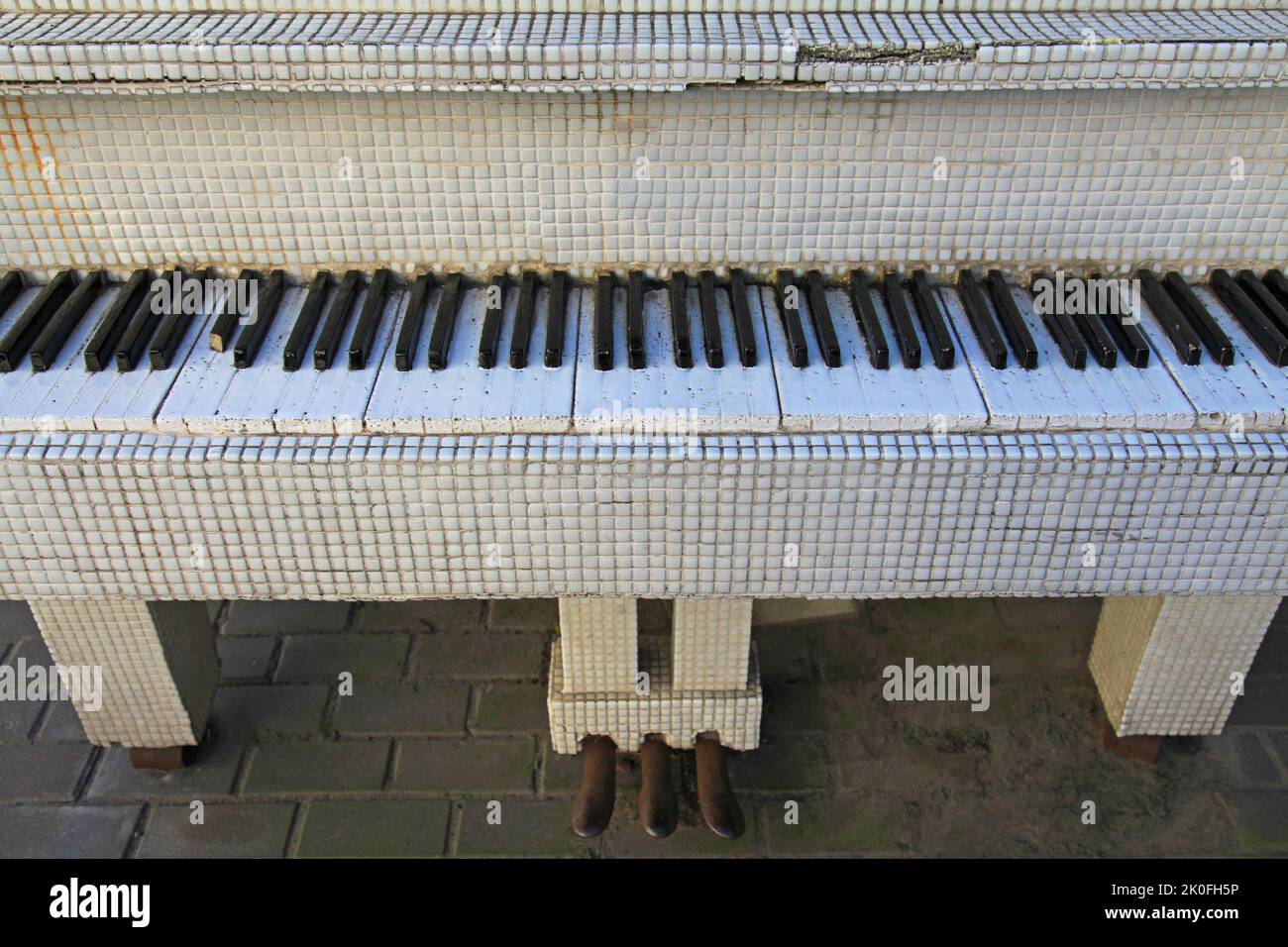Fragment of a white decorative street piano, covered with the square ...
