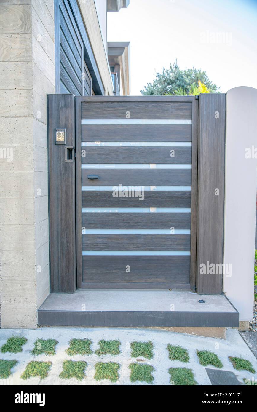 Wooden gate with glass panels of a house in Del Mar Southern California ...