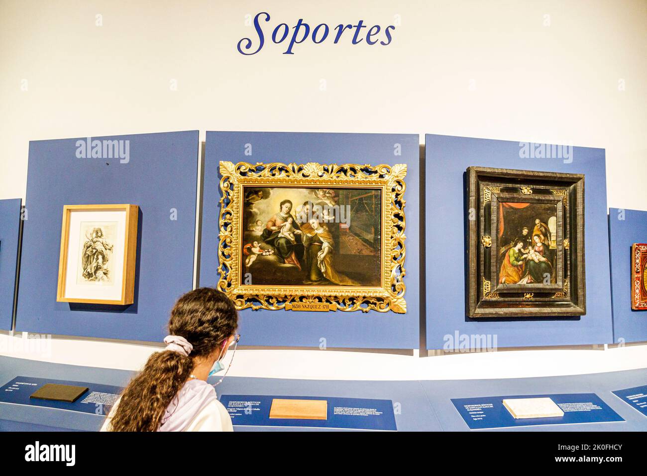 Girl girls female student students looking paintings wood frames ...