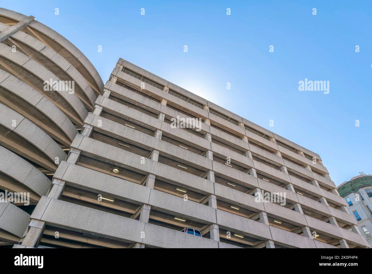 Exterior view of multi level parking lot against blue sky on a sunny ...