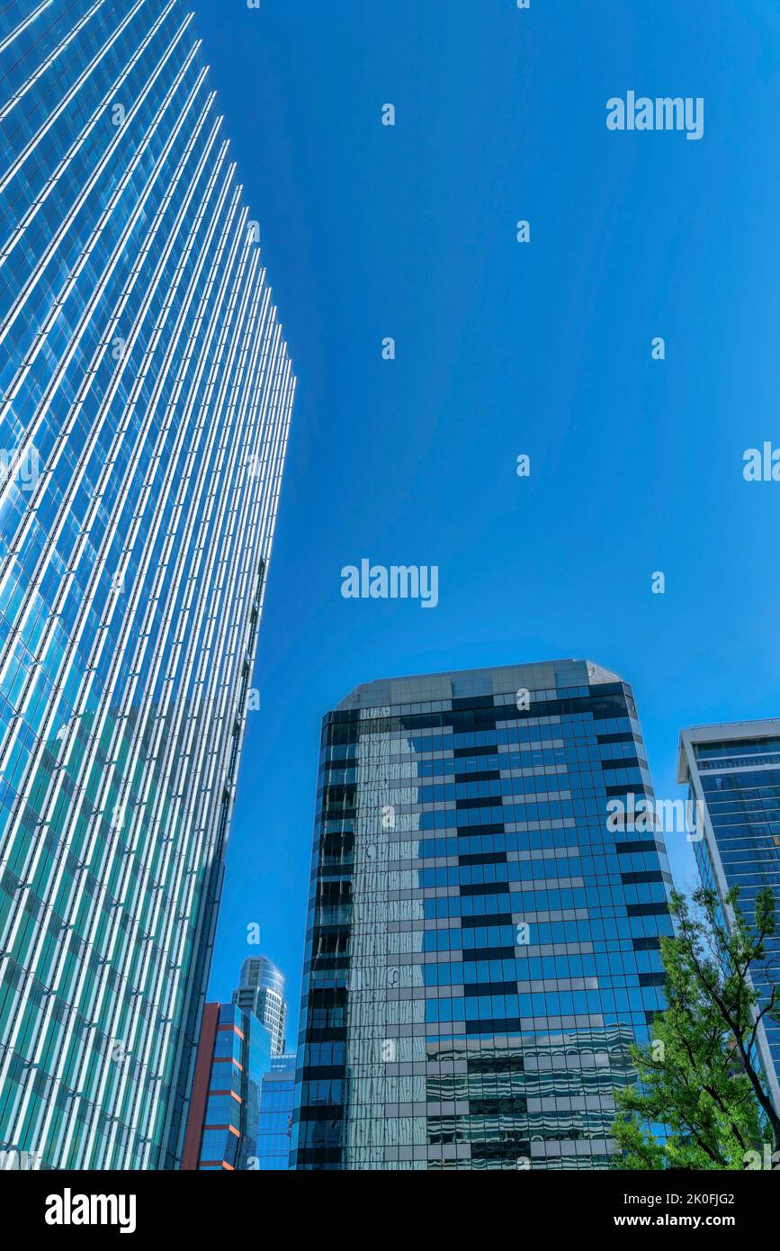 Skyscrapers apartments exterior view with cloudless blue sky background ...