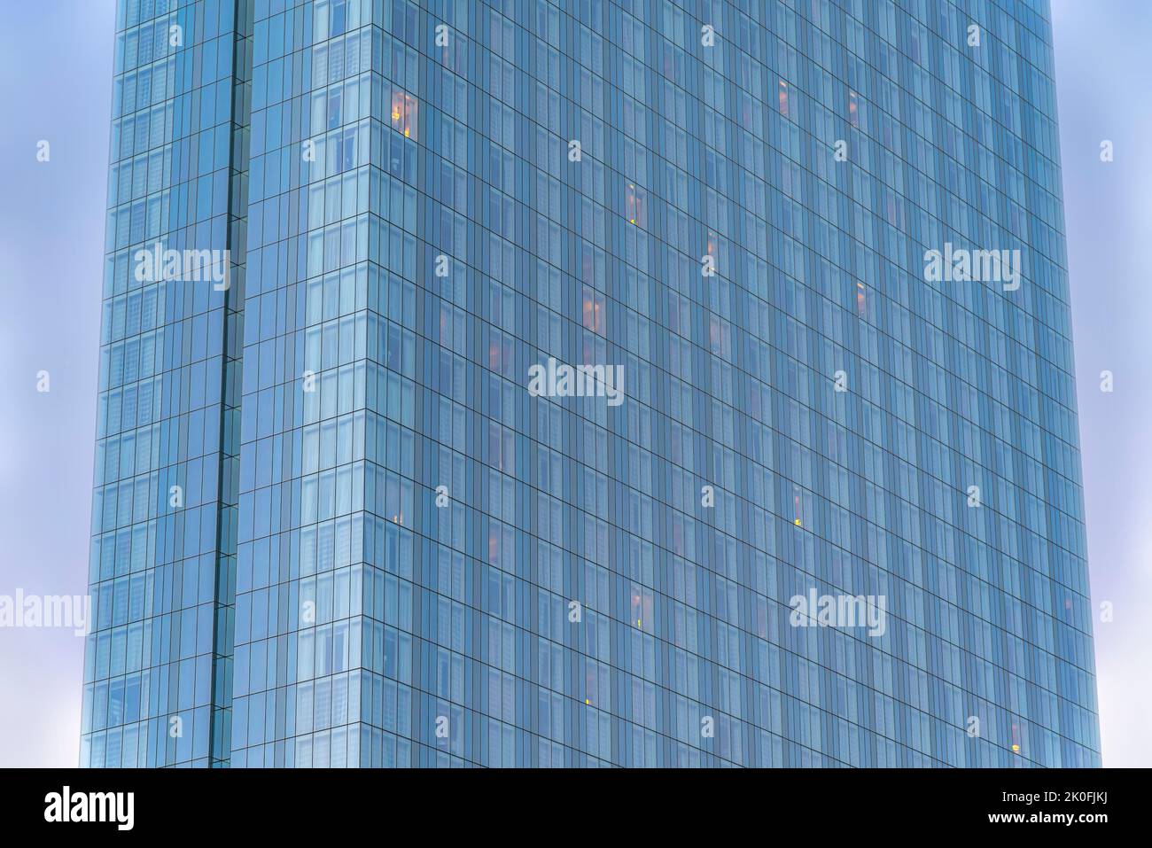 Towering skyscraper with glass windows and bright blue sky in the ...