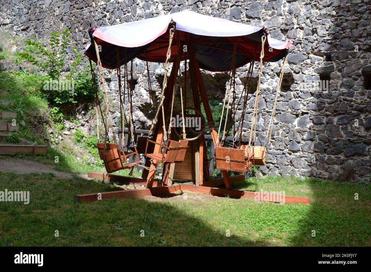 Historic wooden carousel at Trosky castle ruin in Czech Republic Stock ...