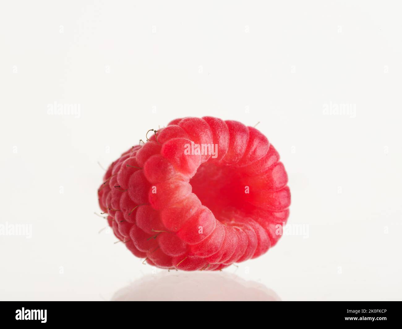 One ripe red raspberry on a white background. Minimalism. Vitamins ...