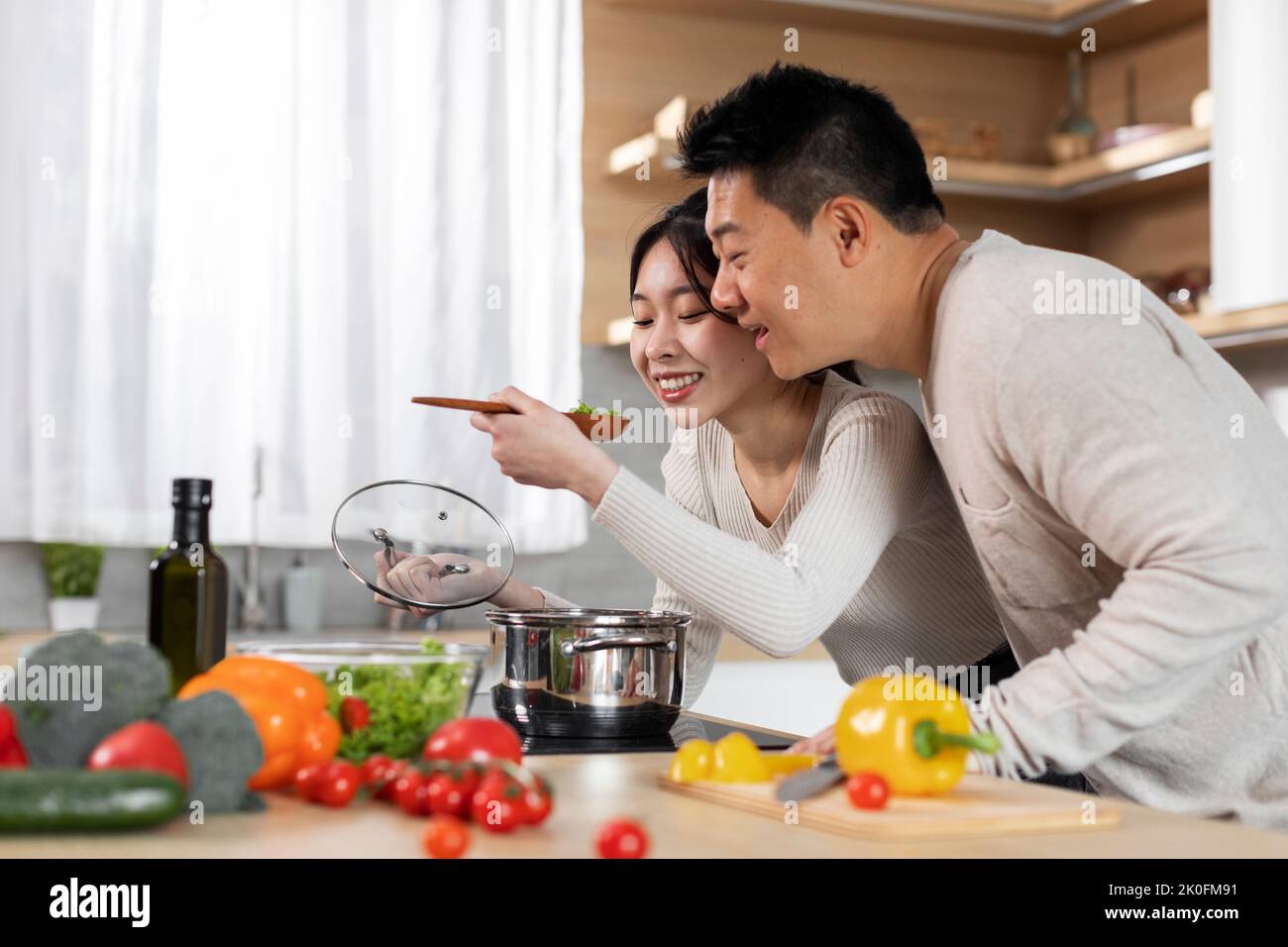 Excited korean family cooking together at home Stock Photo - Alamy