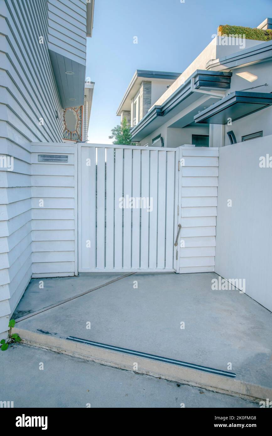 La Jolla, California- Wooden painted white single gate at the side of a ...