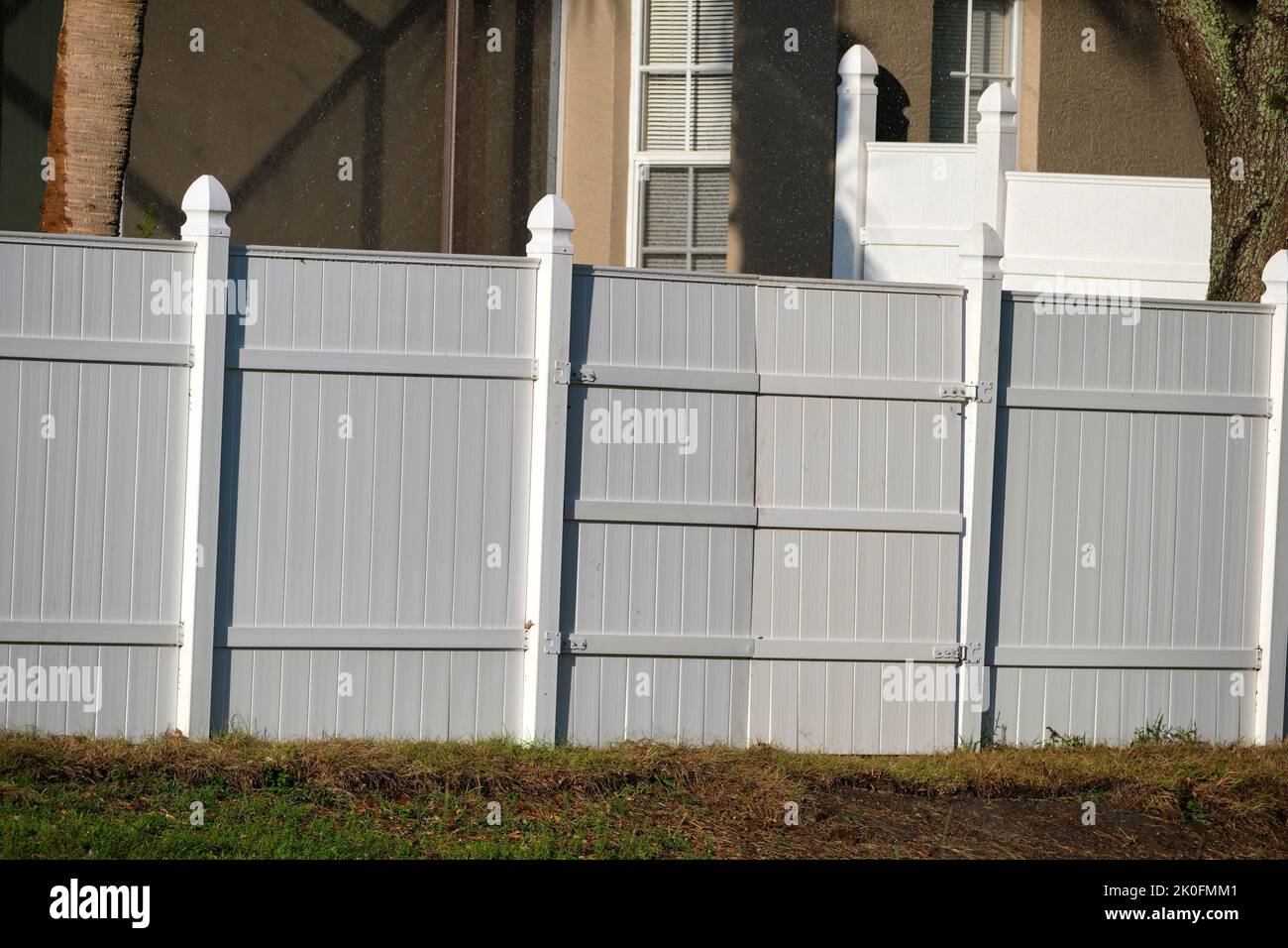 White plastic fence for back yard protection and privacy Stock Photo ...