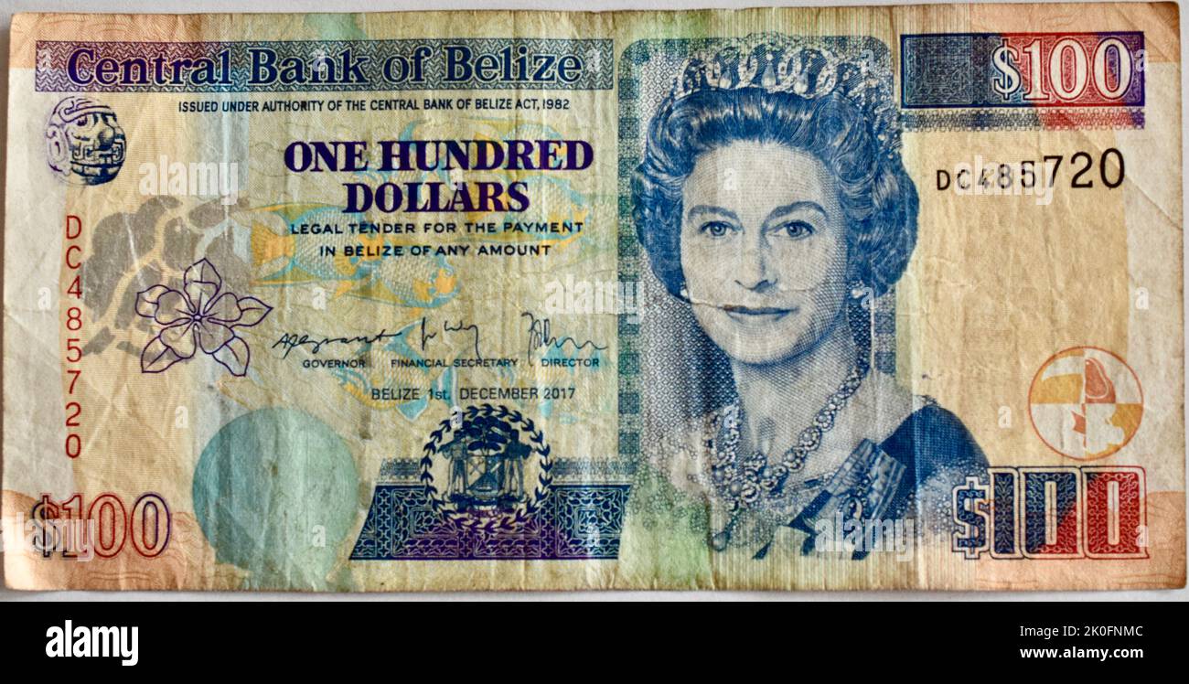A $100 Belizean dollar bill with Queen Elizabeth II's portrait on it ...