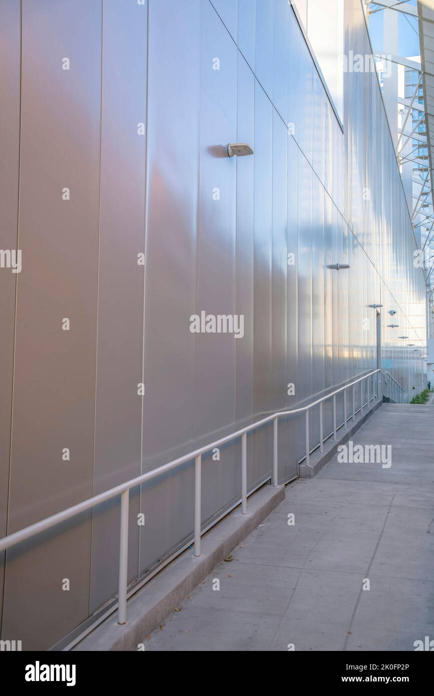 Footpath with handrails near the metal wall of a building at Phoenix ...