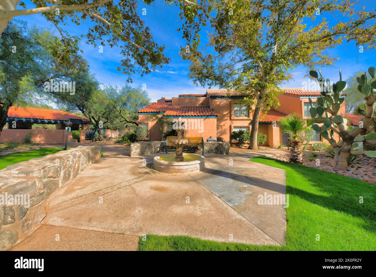 Small fountain and garden bench near the houses in Tucson, Arizona ...