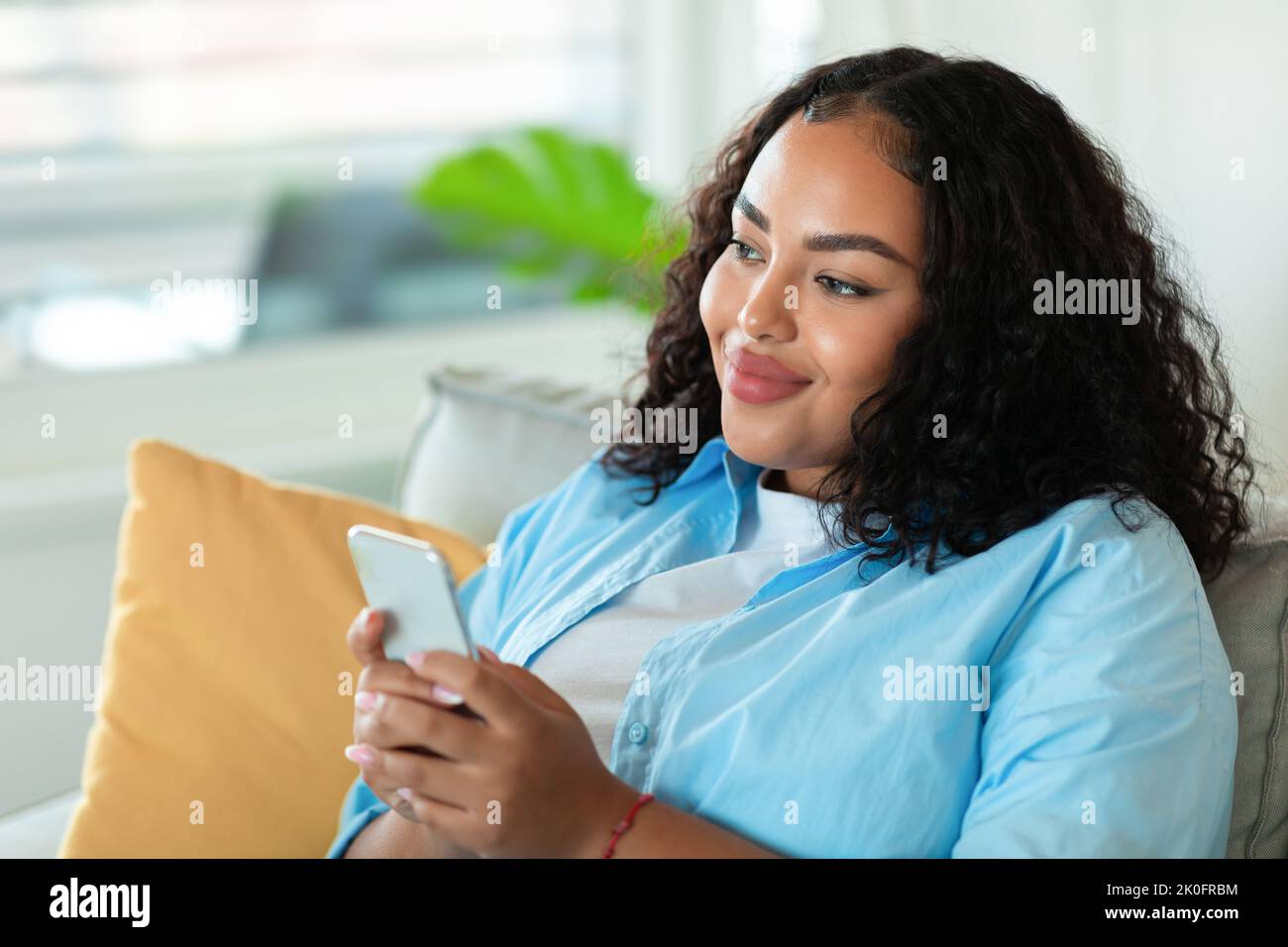 Positive african woman texting mobile hi-res stock photography and ...