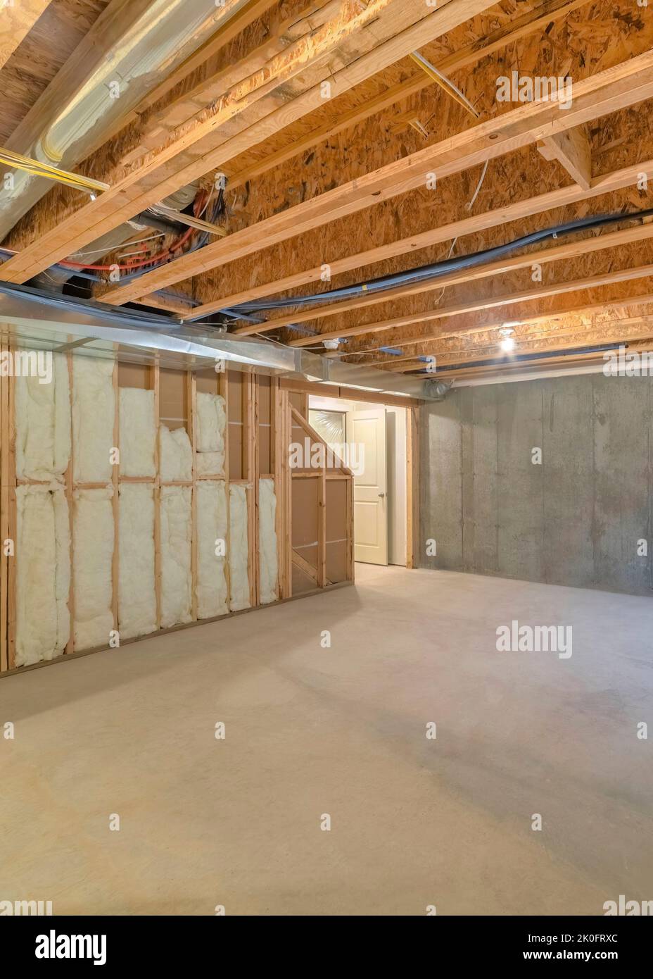 Vertical Unfinished basement with a plastic vapor barrier on the wall ...