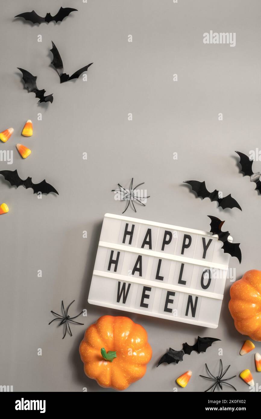 Happy Halloween lightbox sign board with pumpkin, bats and candy on a ...