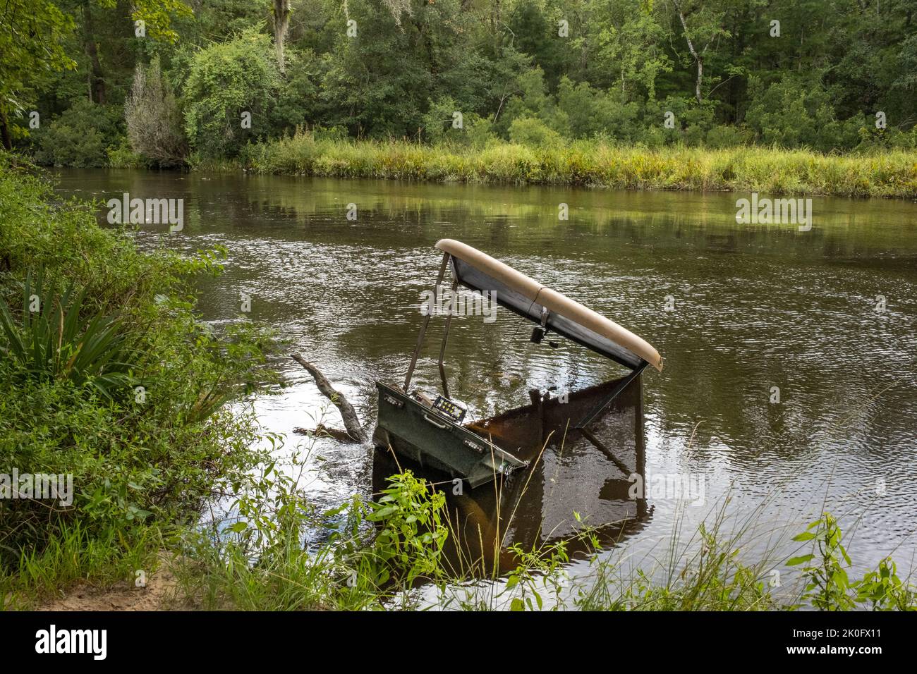 An abandoned boat slowly sinks into the river Stock Photo - Alamy