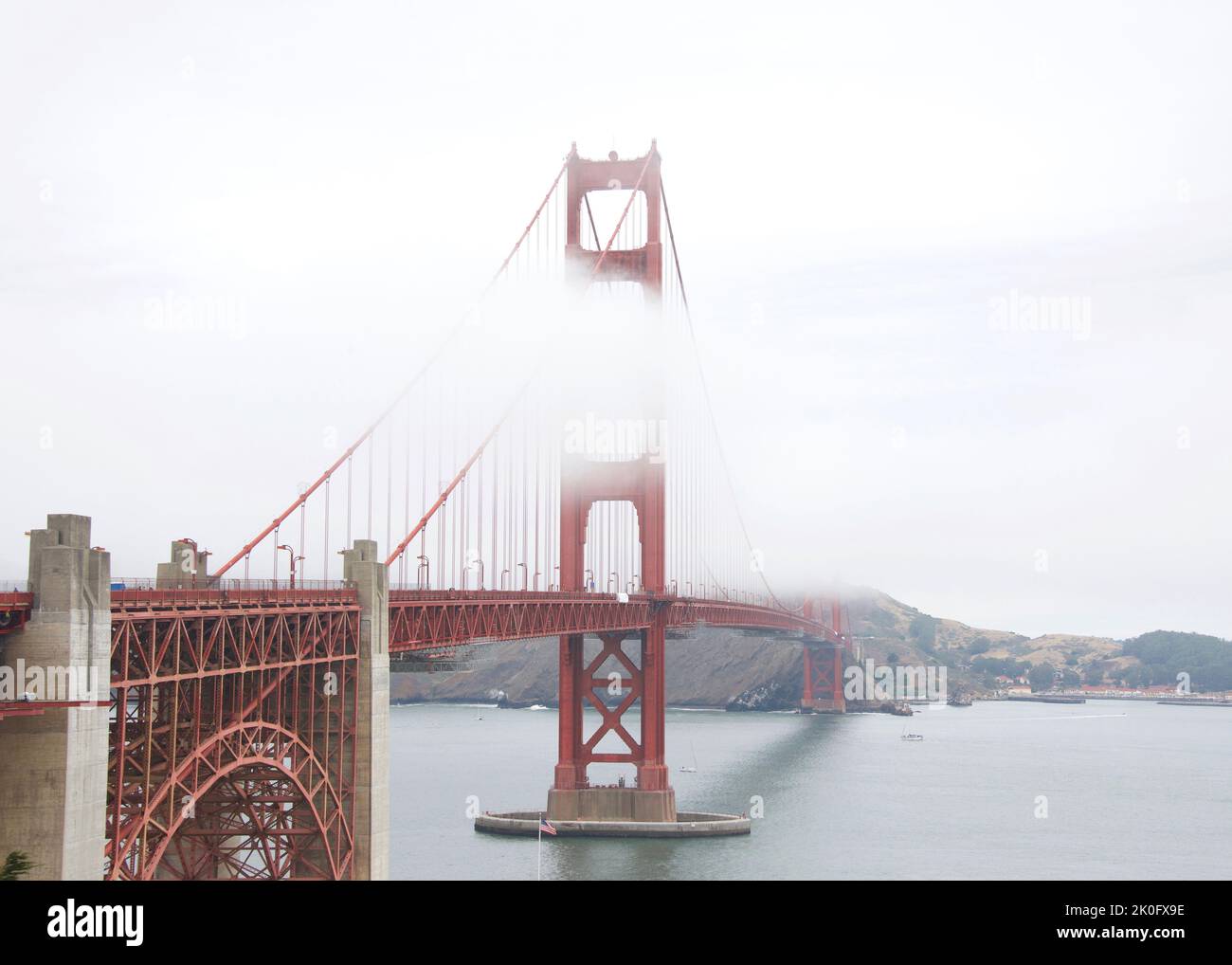 Golden Gate Bridge on a cloudy foggy morning, clouds rolling through ...