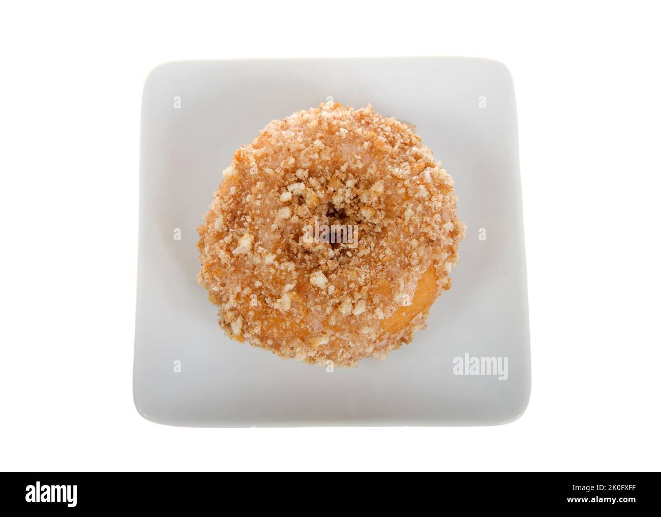 Top view flat lay of one crumb coated cinnamon cake donut on a small ...