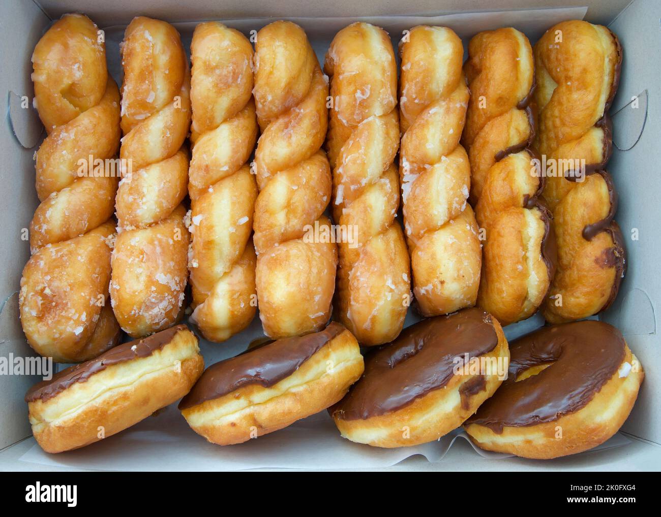 Above top vie of glazed twist and chocolate glazed twist donuts lined ...