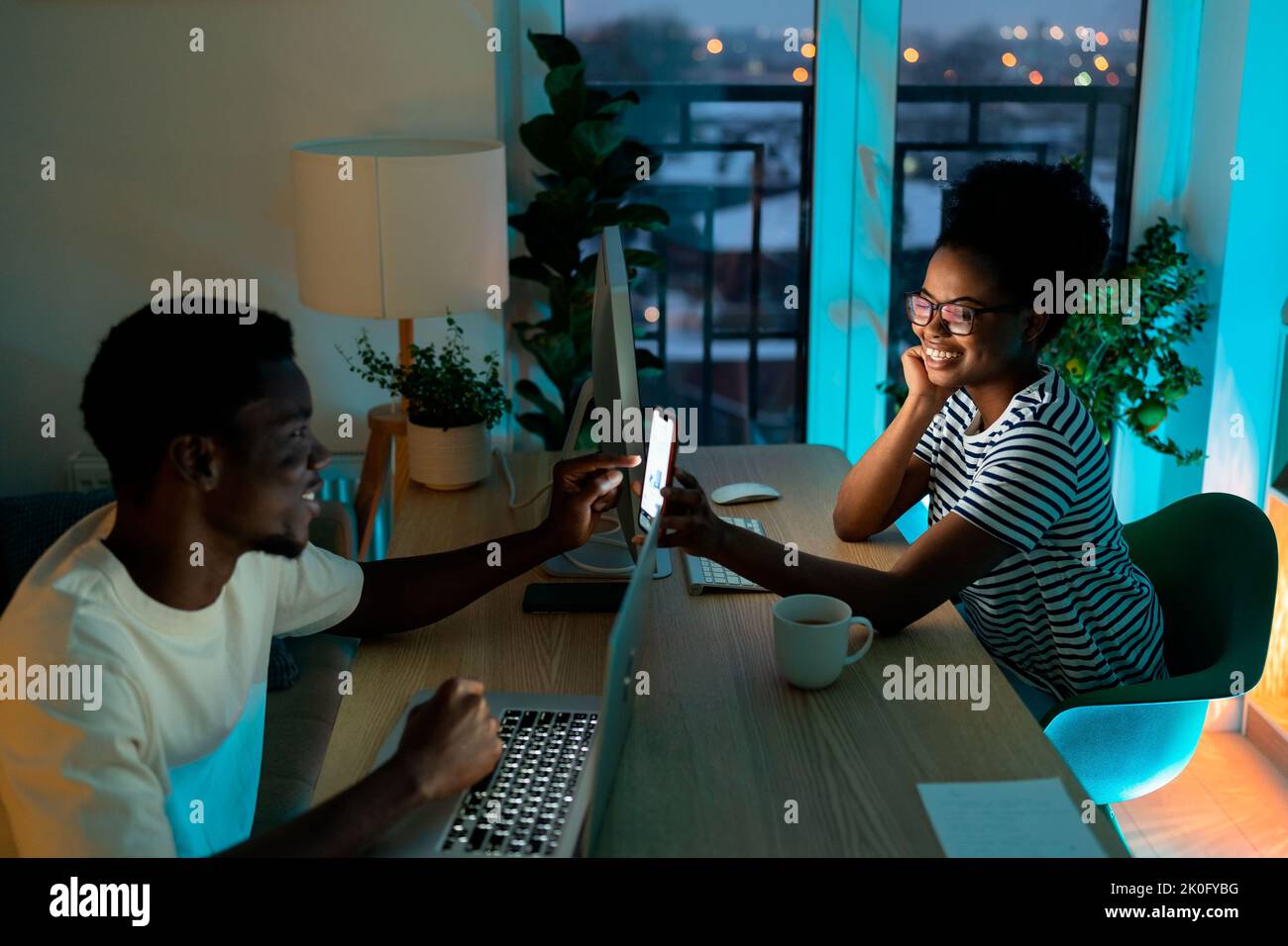 African American woman shows happy boyfriend funny messages on ...