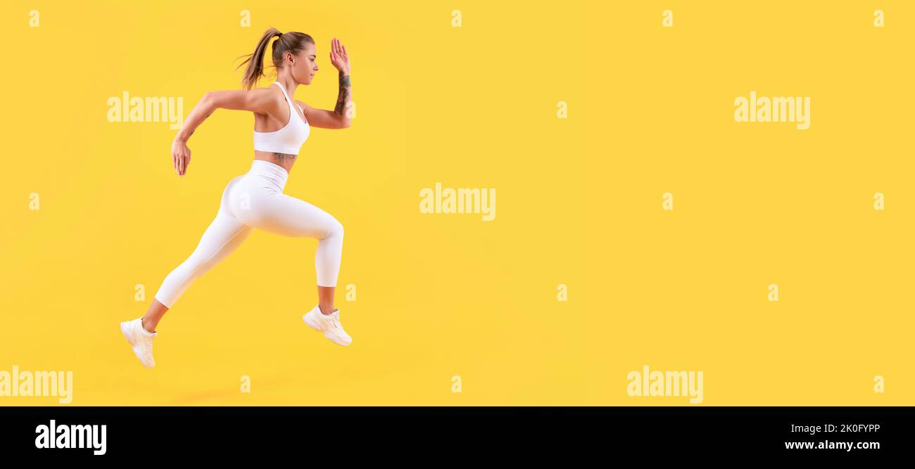 energetic fitness woman runner running on yellow background. Woman ...