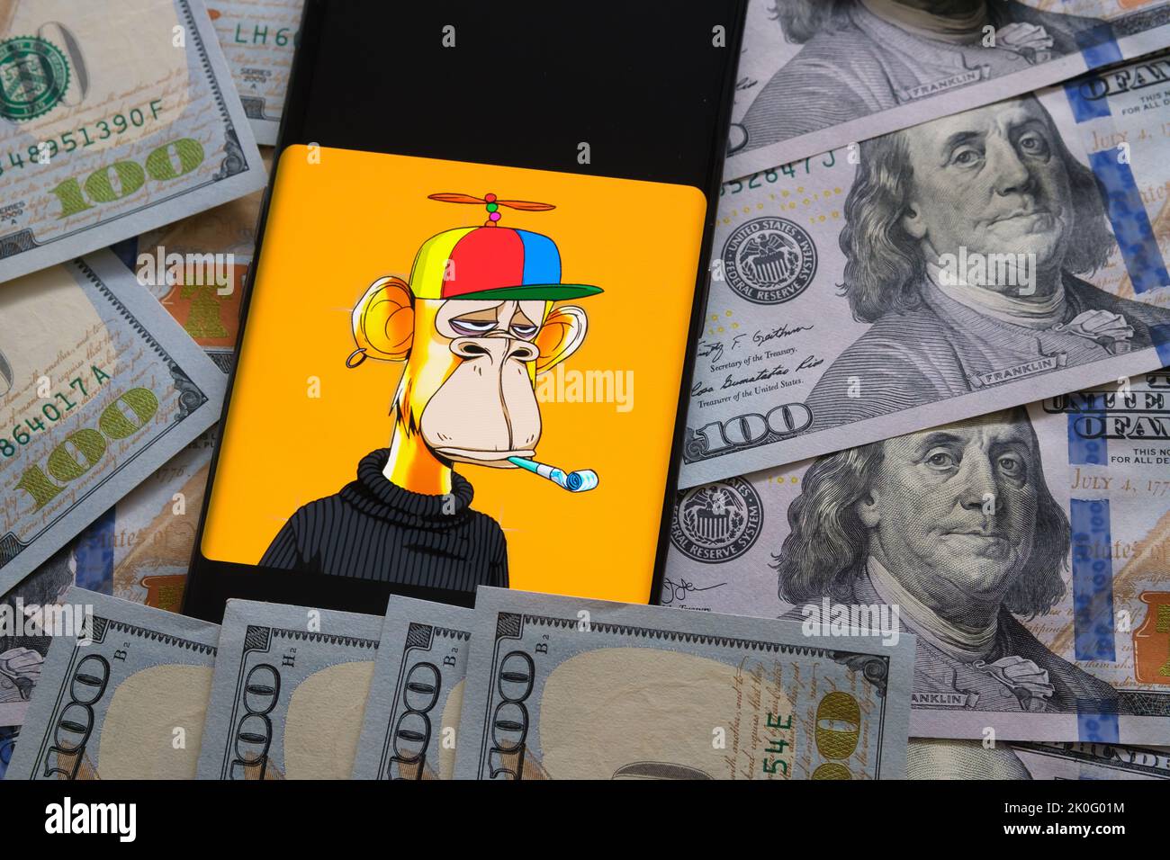 Bored Ape #8817 NFT seen on the smartphone screen placed on pile of ...