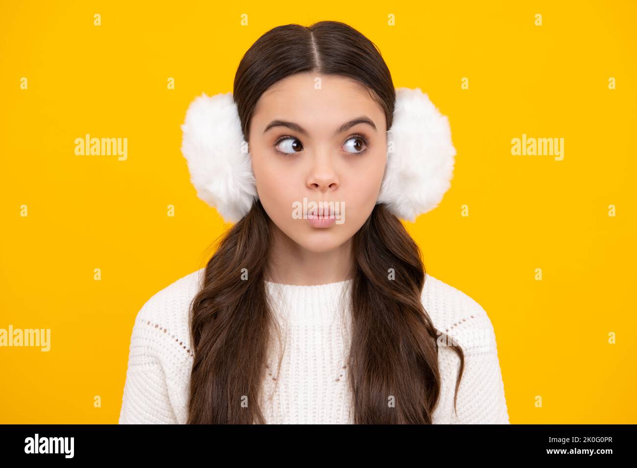 Modern teenage girl 12, 13, 14 year old wearing sweater and winter warm ...