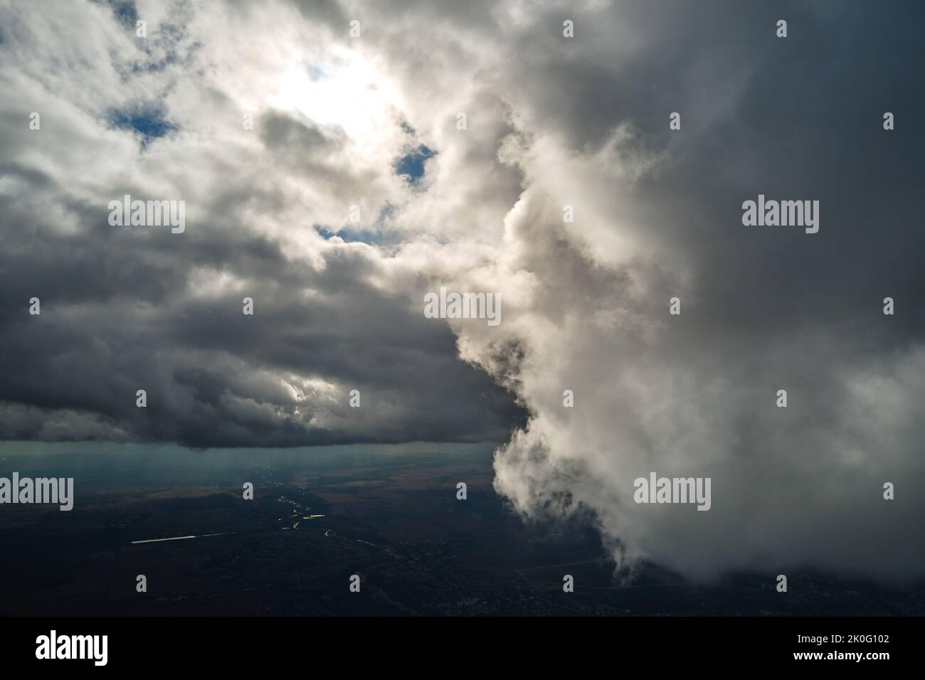 Aerial view from airplane window at high altitude of distant city ...