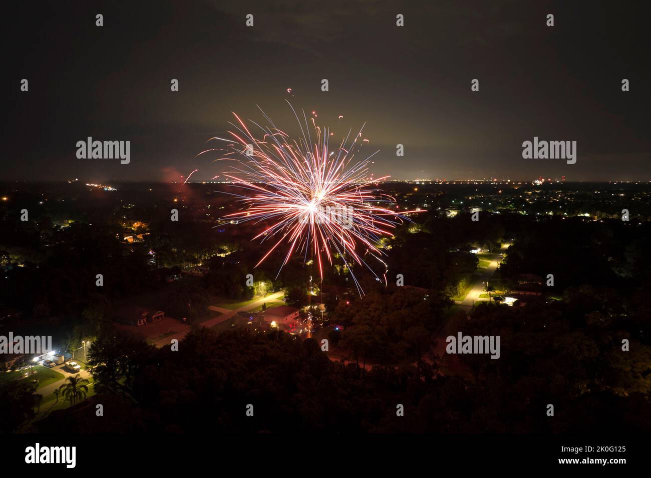 Aerial view of bright fireworks exploding with colorful lights over ...
