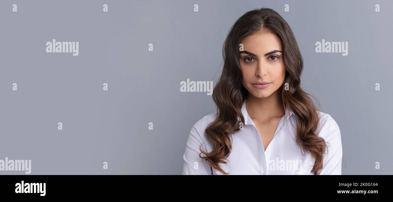 Serious confident business woman hold arms crossed grey, confidence. Woman isolated face ...