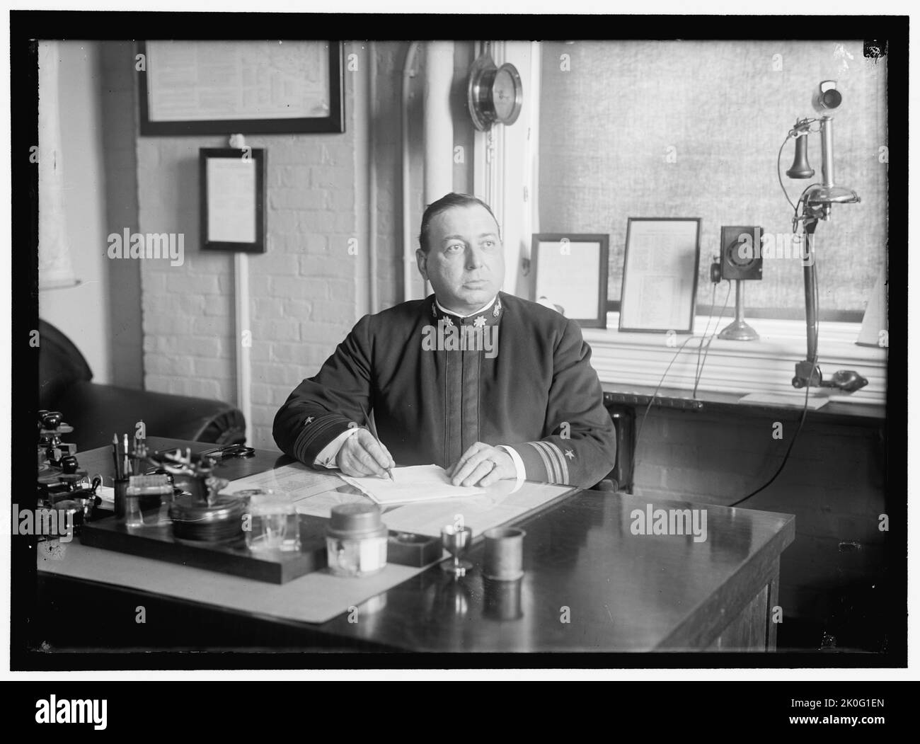 Captain William, between 1910 and 1917. Man in uniform writing at a ...