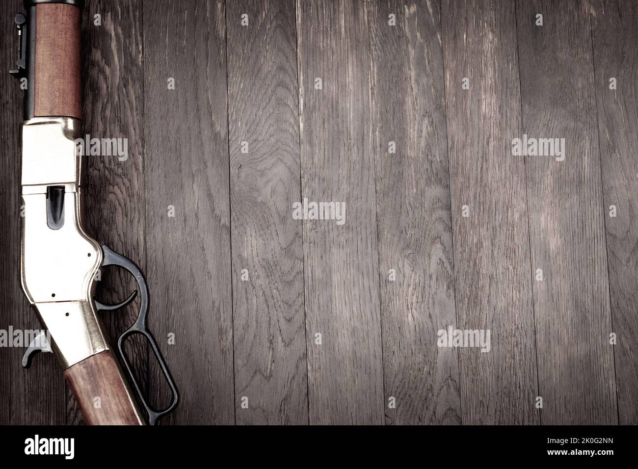 Old west gun - lever-action repeating rifle on wooden table Stock Photo ...