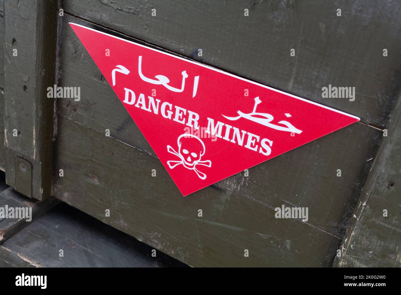 Arabic/English minefield warning red sign - Danger Mines. White skull ...