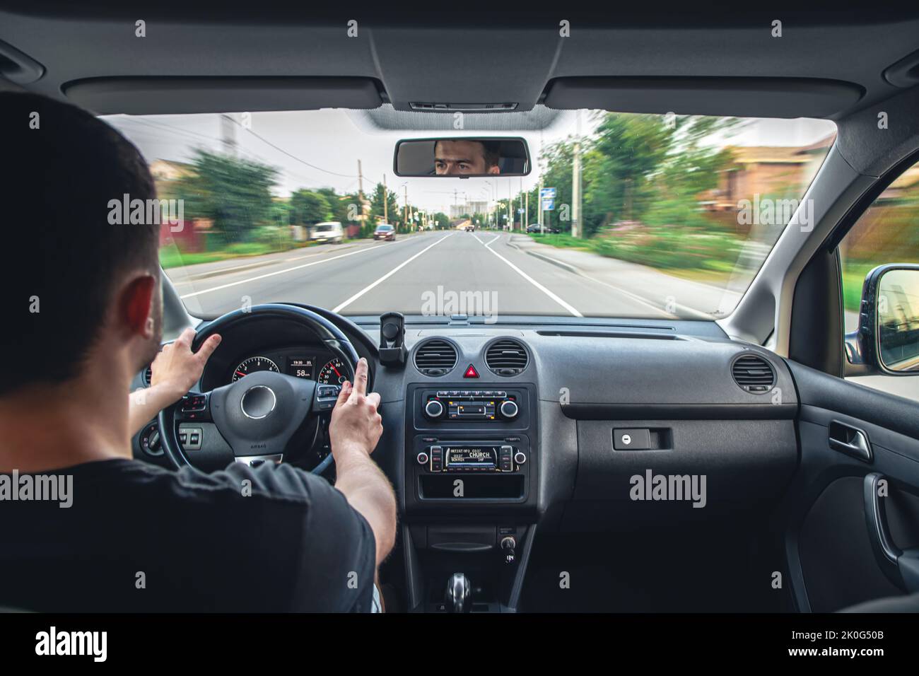 Hands on the wheel when driving at high speed from inside the car Stock Photo - Alamy