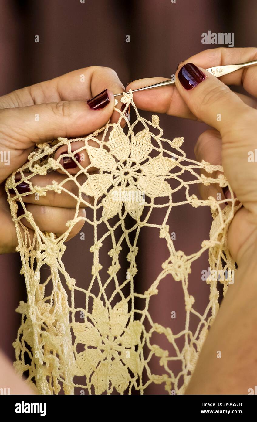 Handmade Brazilian lace crochet. Close-up artisan hands crocheting ...