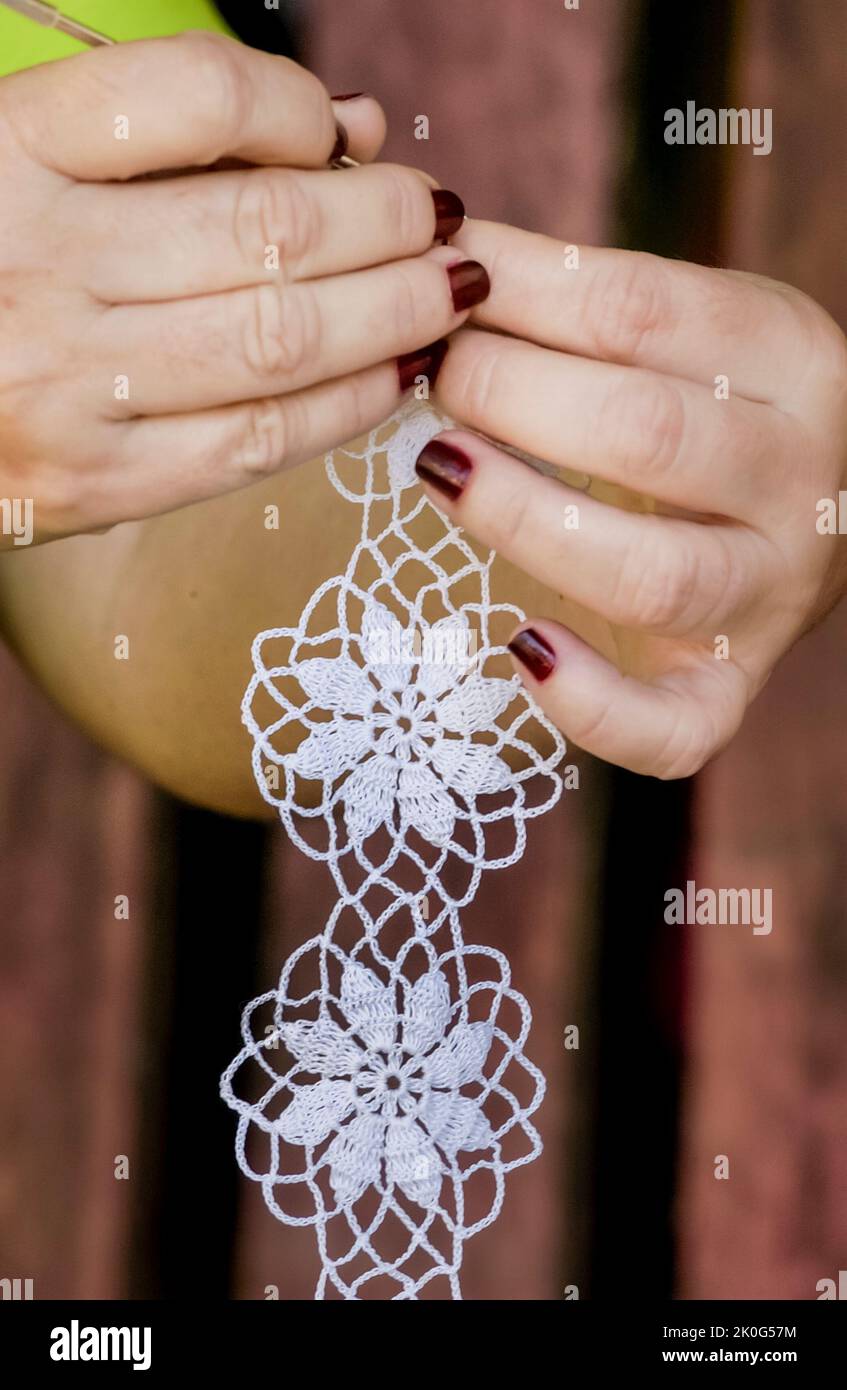 Handmade Brazilian lace crochet. Close-up artisan hands crocheting ...