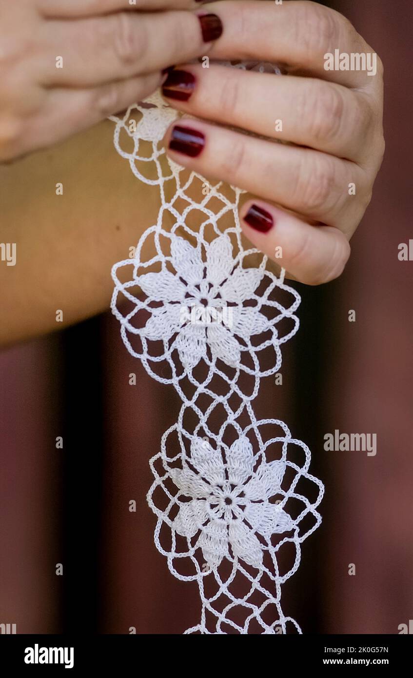 Handmade Brazilian lace crochet. Close-up artisan hands crocheting ...