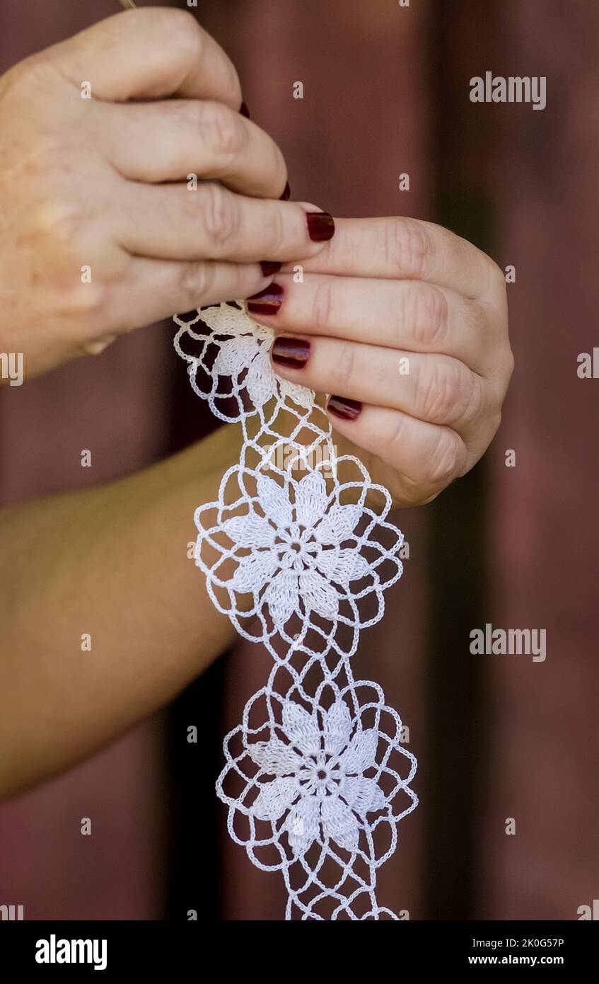 Handmade Brazilian lace crochet. Close-up artisan hands crocheting ...