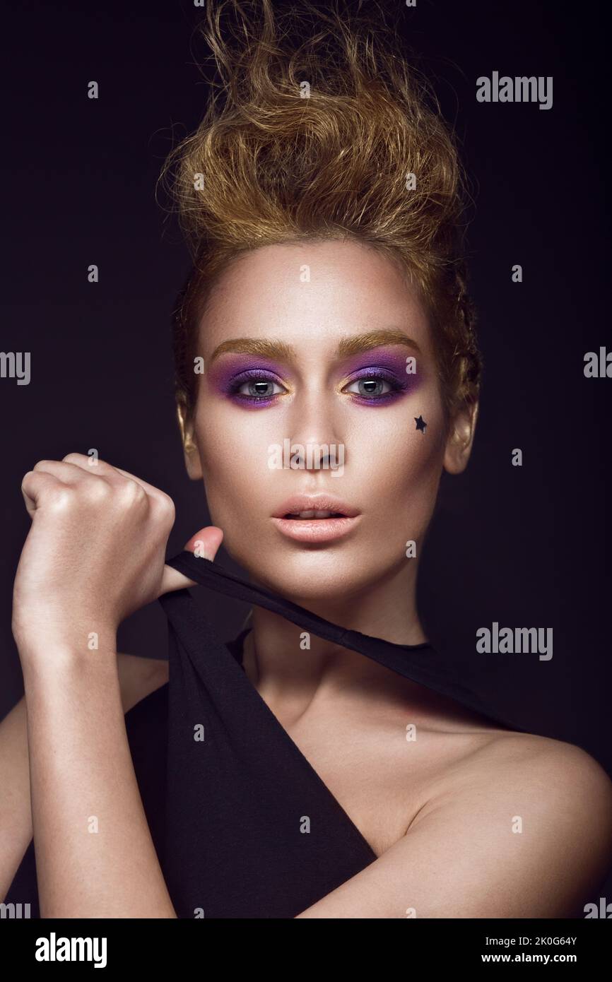 Daring girl with a mohawk hairstyle, painted in gold, punk style. Beauty face Stock Photo - Alamy