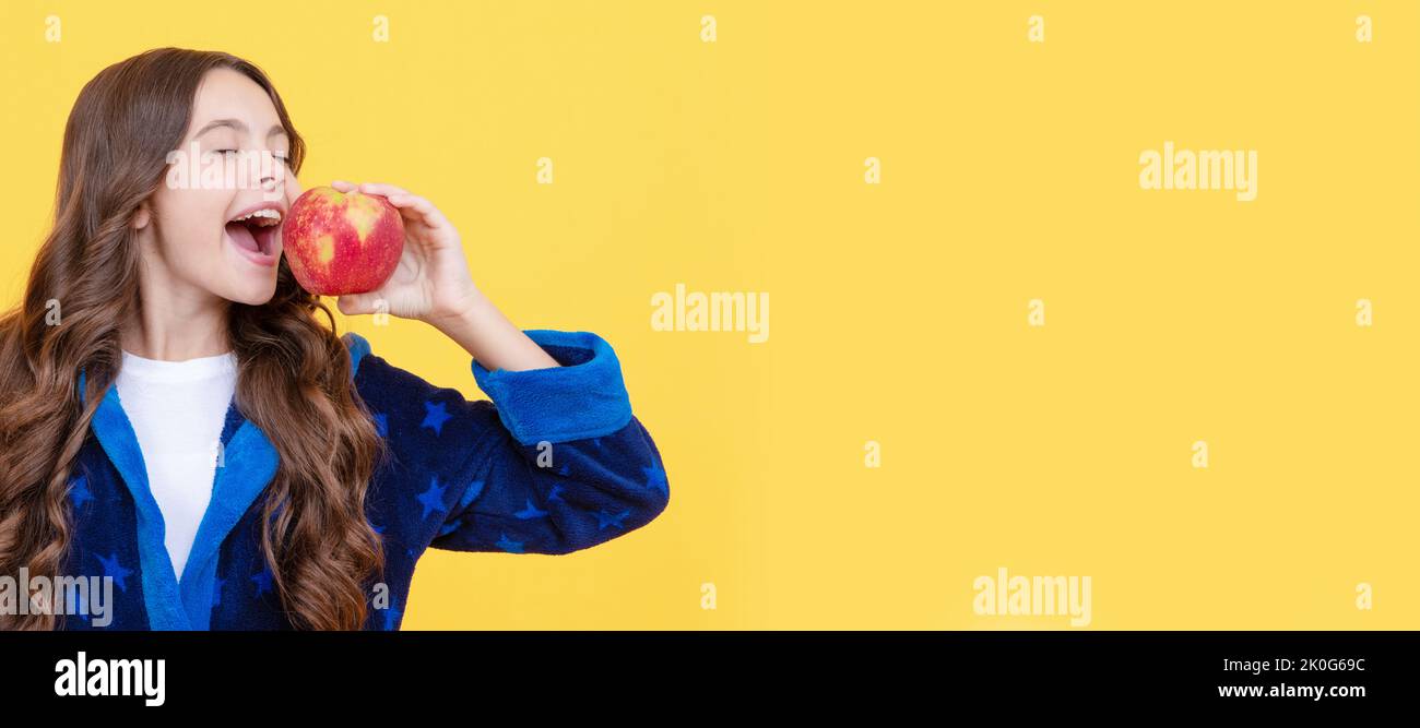 just one bite. happy teen girl with apple fruit. toothy kid has healthy ...