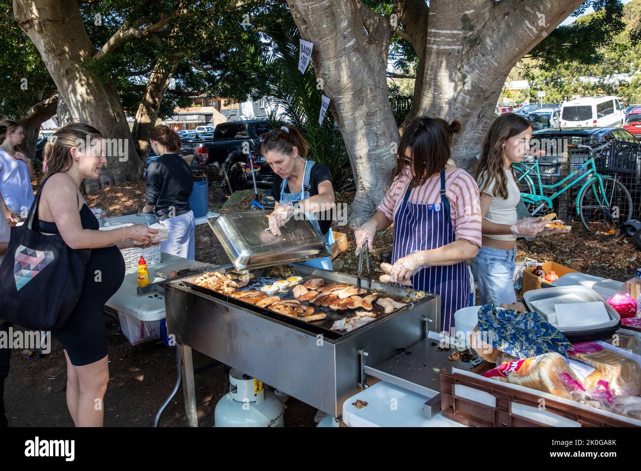 Australian sausage sizzle women ladies cooking breakfast bacon eggs ...