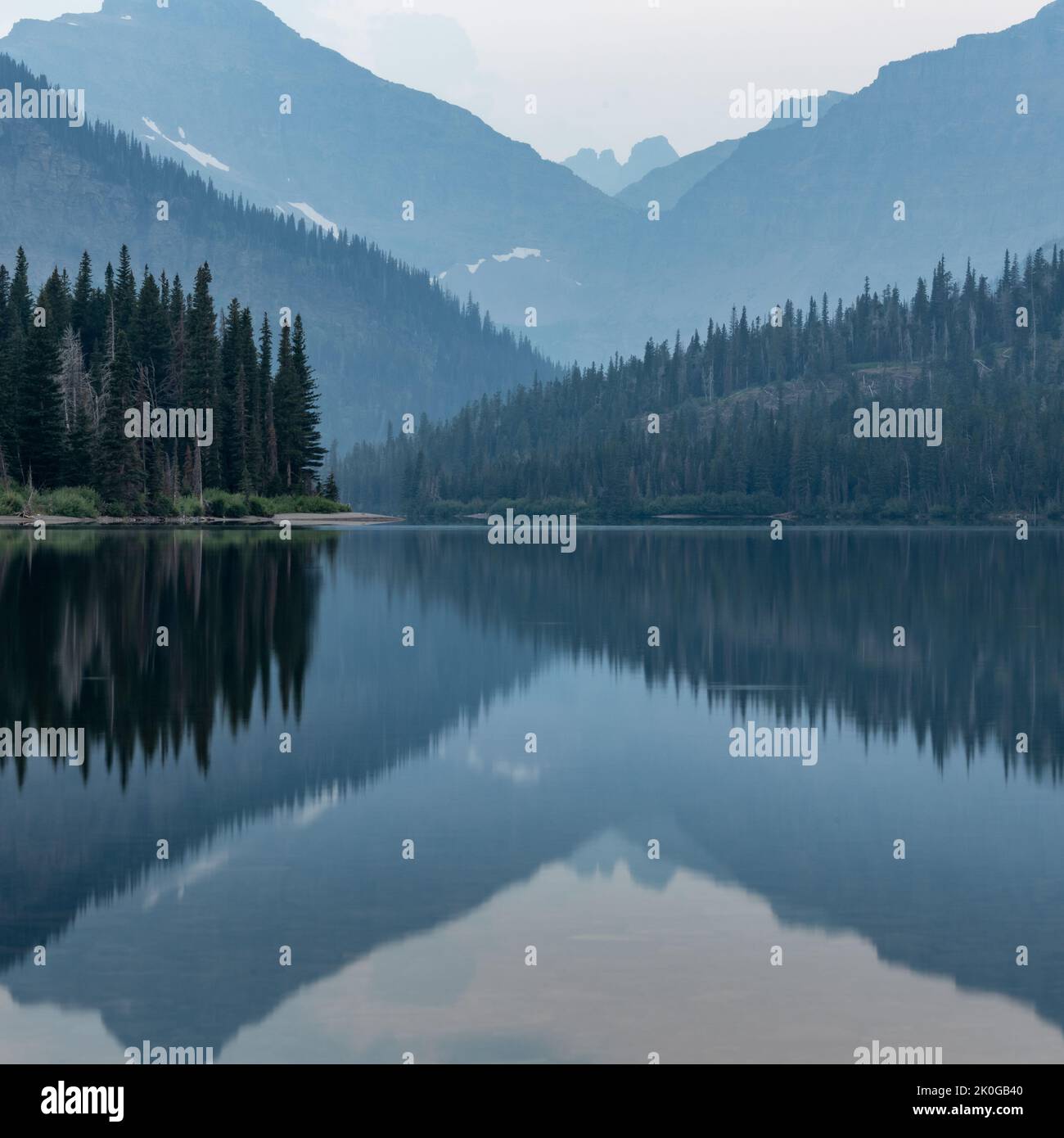 Converging Ridges with Glacier Mountains Over Lake at Dawn Stock Photo ...