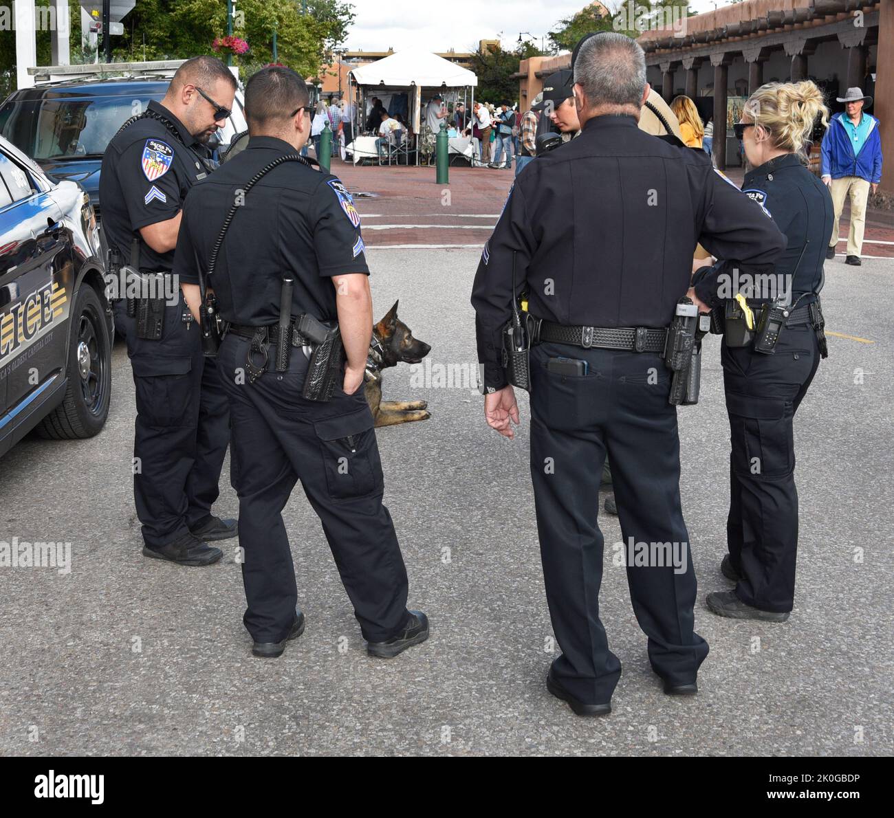 Police officers and a police dog gather for an informal meeting at an ...
