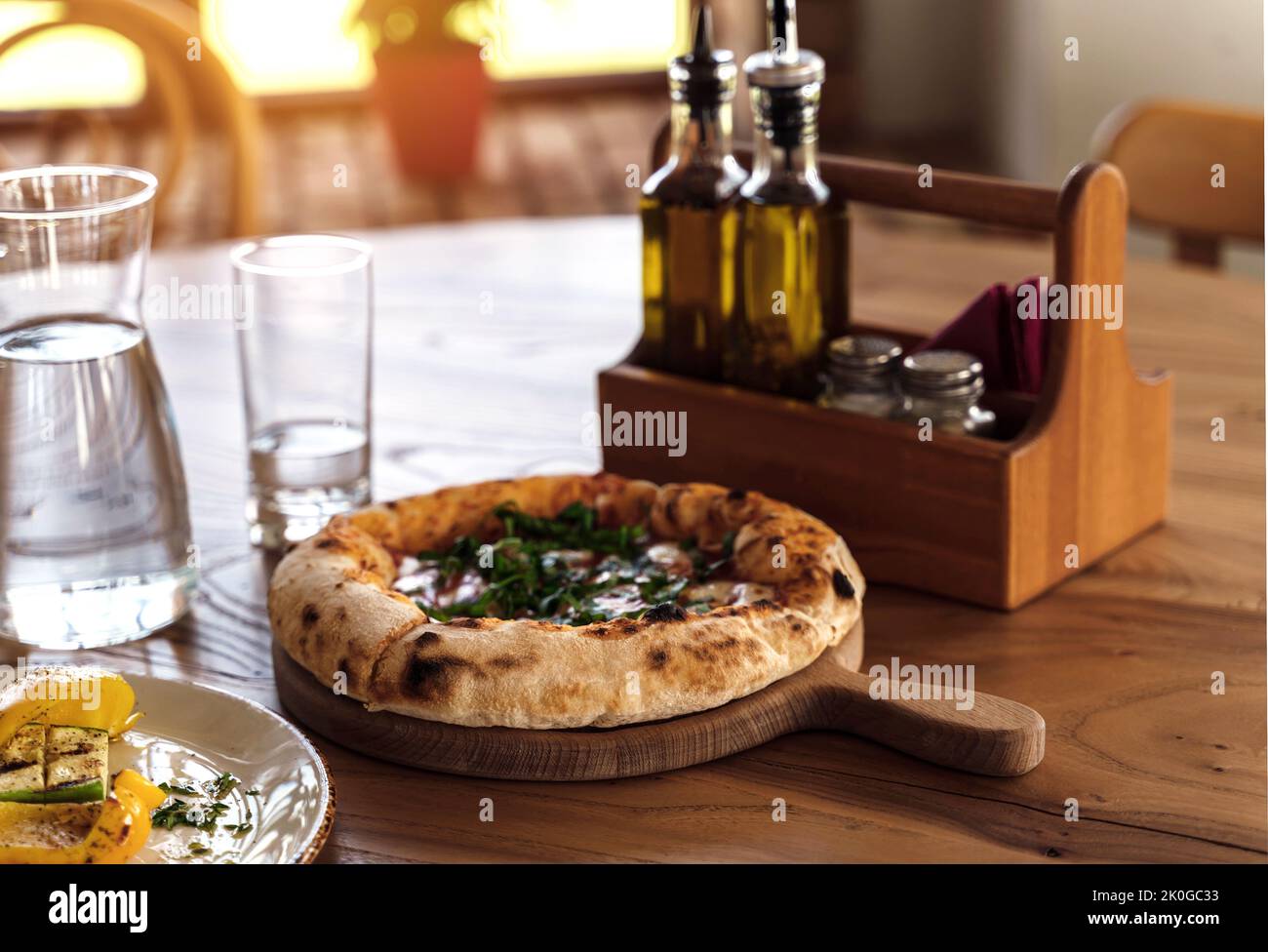 Pizza on wooden table in vintage style. Italian restaurant background ...