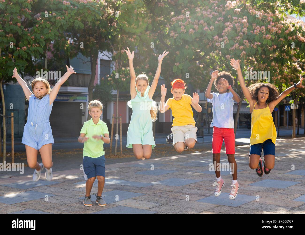 Group of cheerful young girls and boys jumping together Stock Photo - Alamy