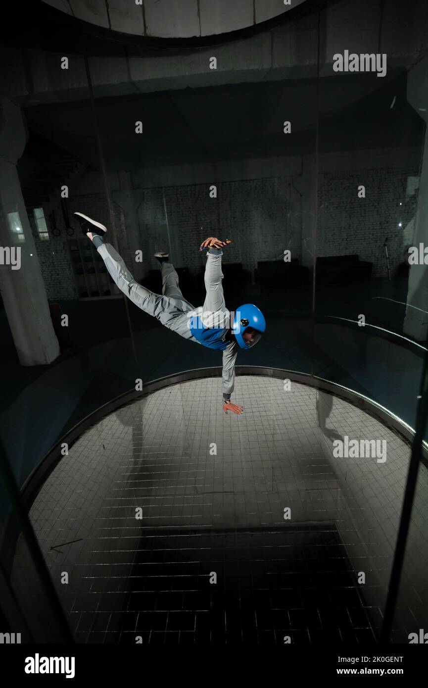 A woman flies in a wind tunnel. Free fall simulator Stock Photo - Alamy