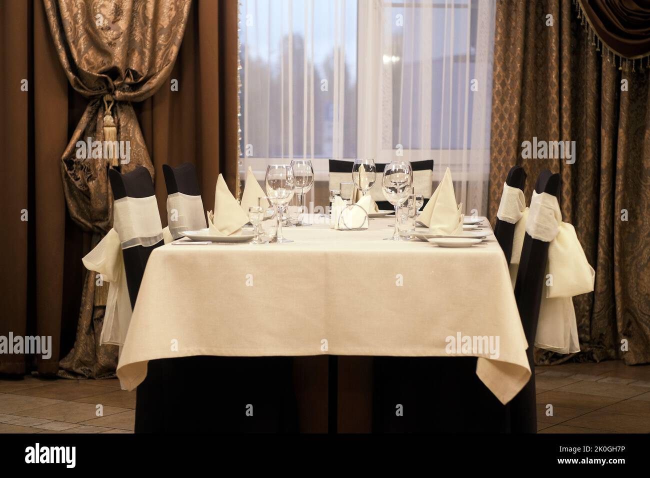 Banquet table with wineglasses. High angle of elegant banquet table served for wedding ...