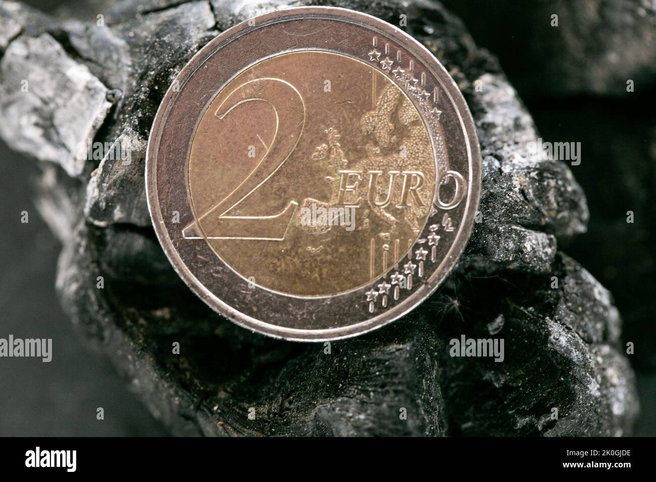 Coal Buying and selling.Two euro coin on a piece of coal.Heating with ...