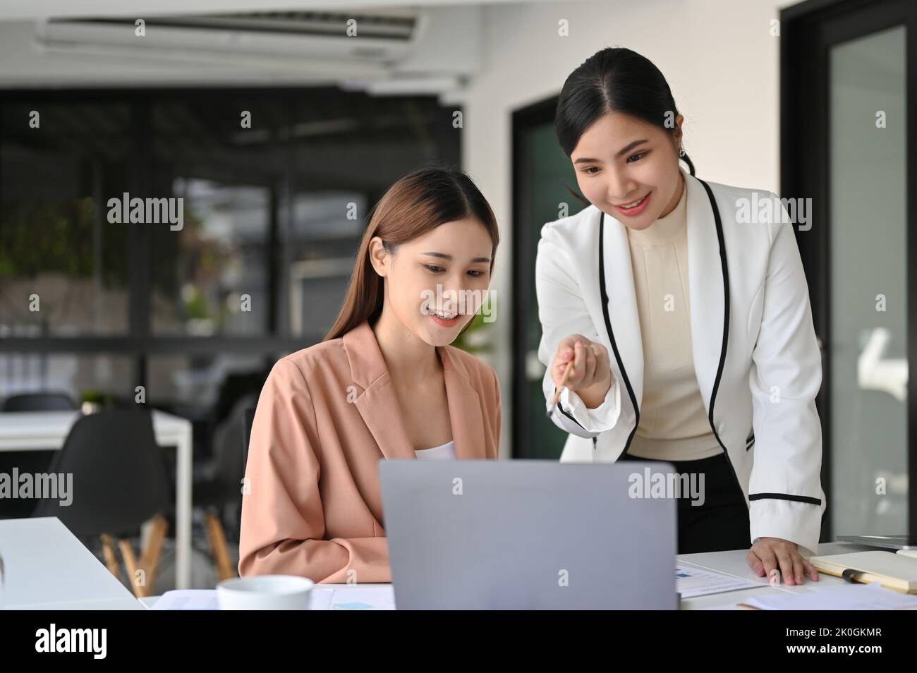 Professional and kind Asian female manager or female boss helping ...