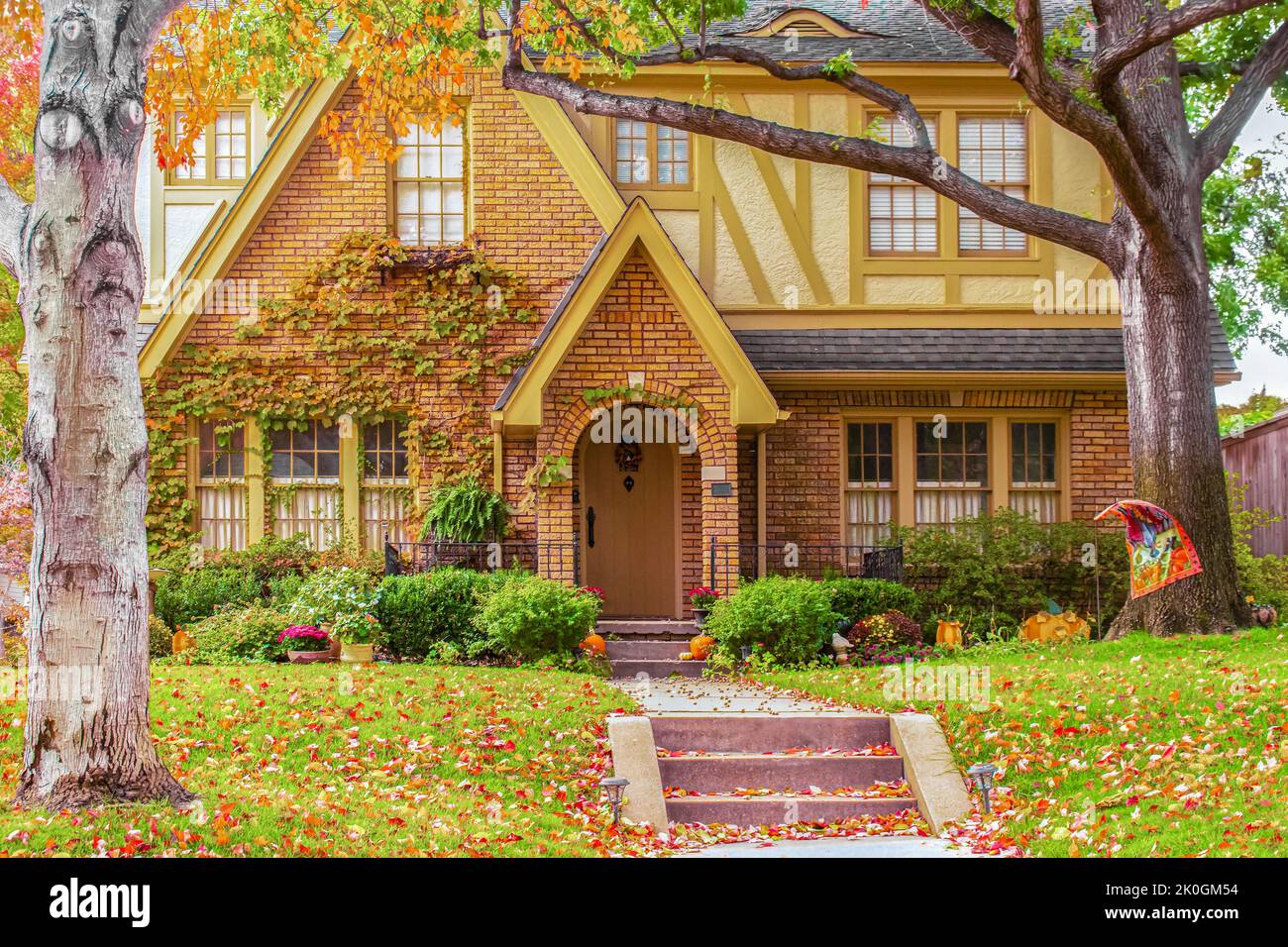 Beautiful half timbered house in Autumn with colorful leaves fallen on ...