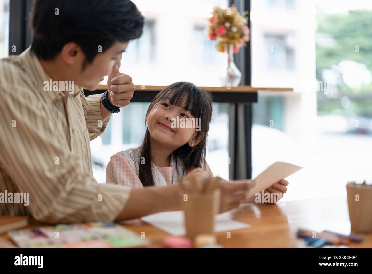Happy proud asian father and daughter having fun together, drawing and ...